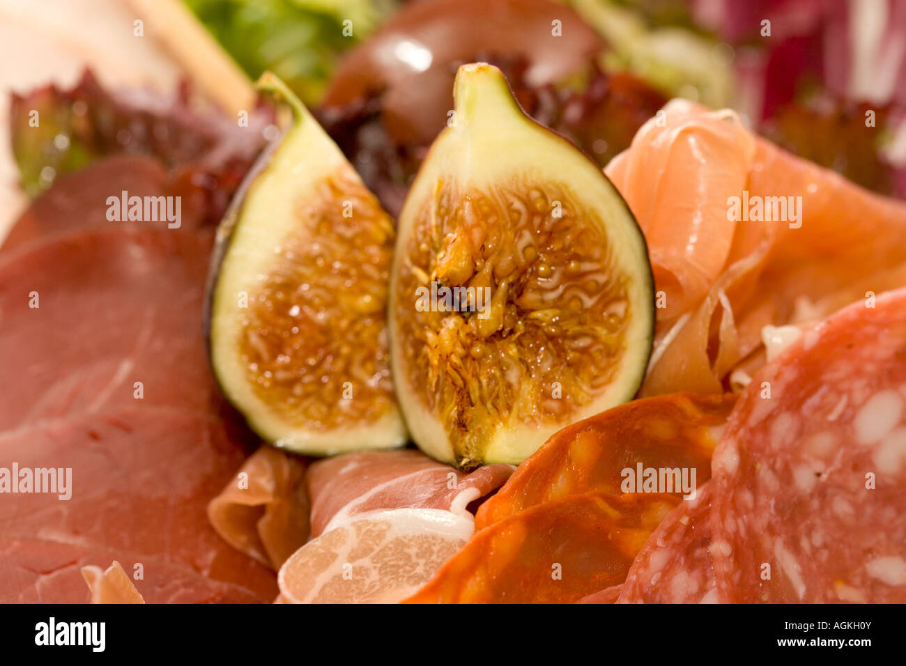 Selection of cooked meats and sliced fig Stock Photo - Alamy