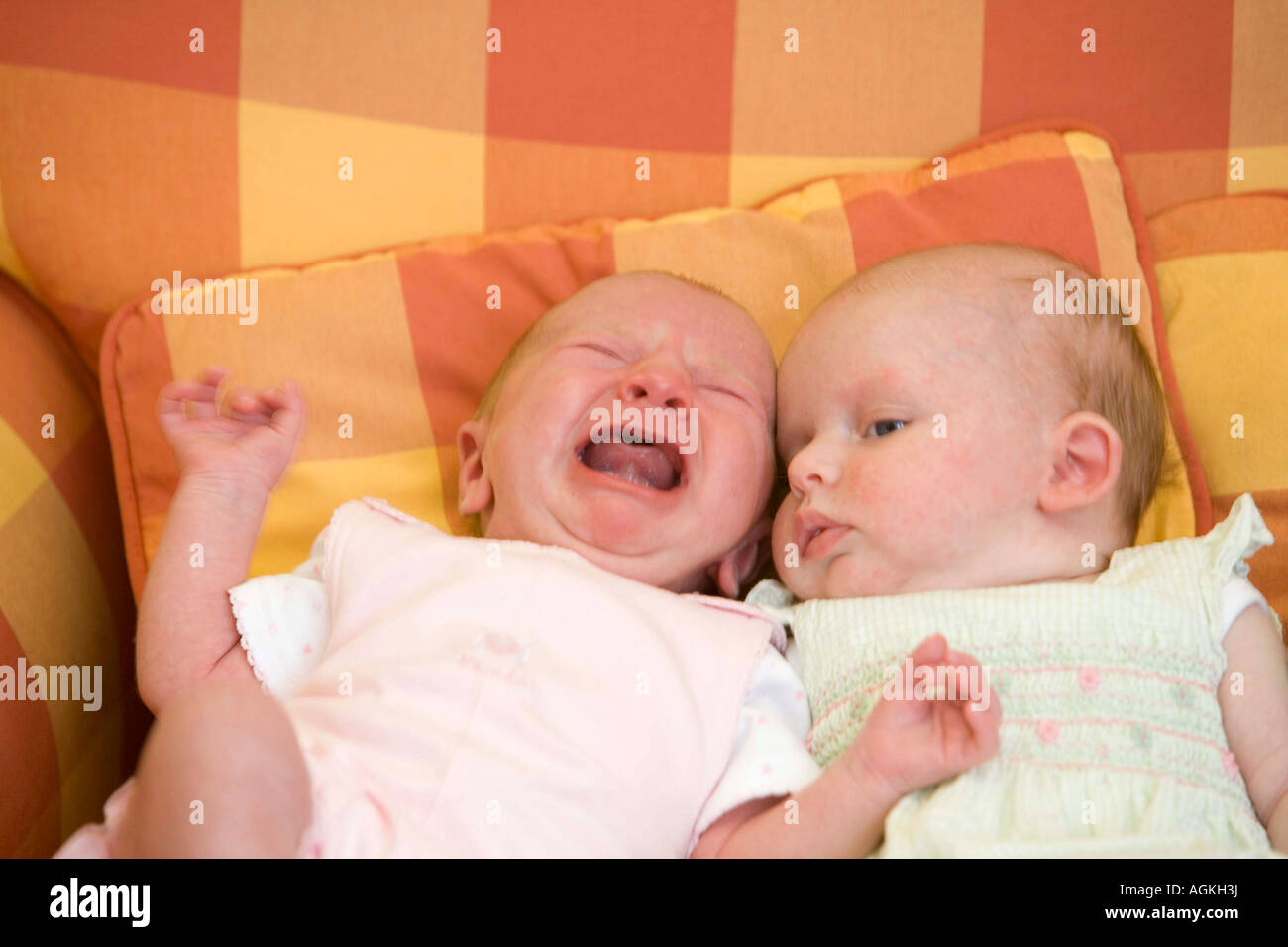 two babies, one crying Stock Photo - Alamy