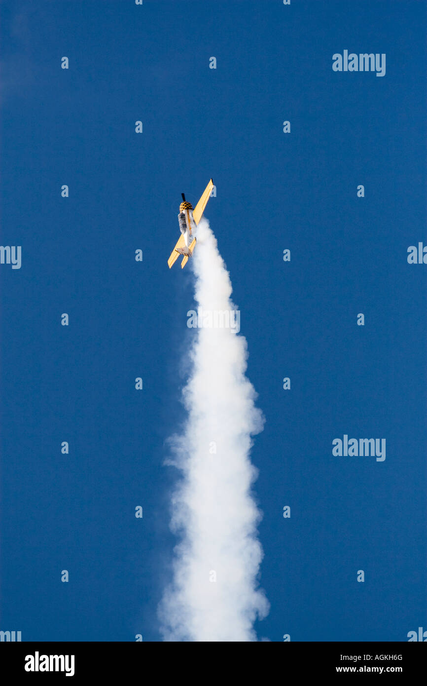 Stunt plane with smoke trails against a blue sky Stock Photo - Alamy