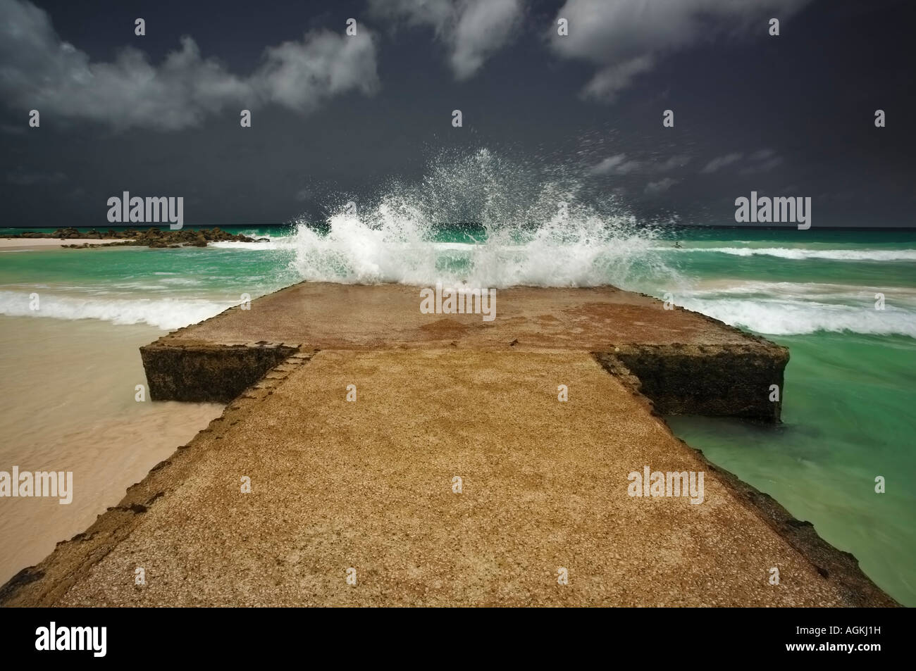 Big wave splashing the pier on a beautiful Needham’s Point Peninsula ...