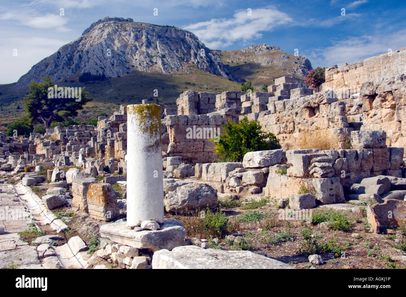Ruins of the ancient city of Corinth with the Acropolis of Acrocorinth ...