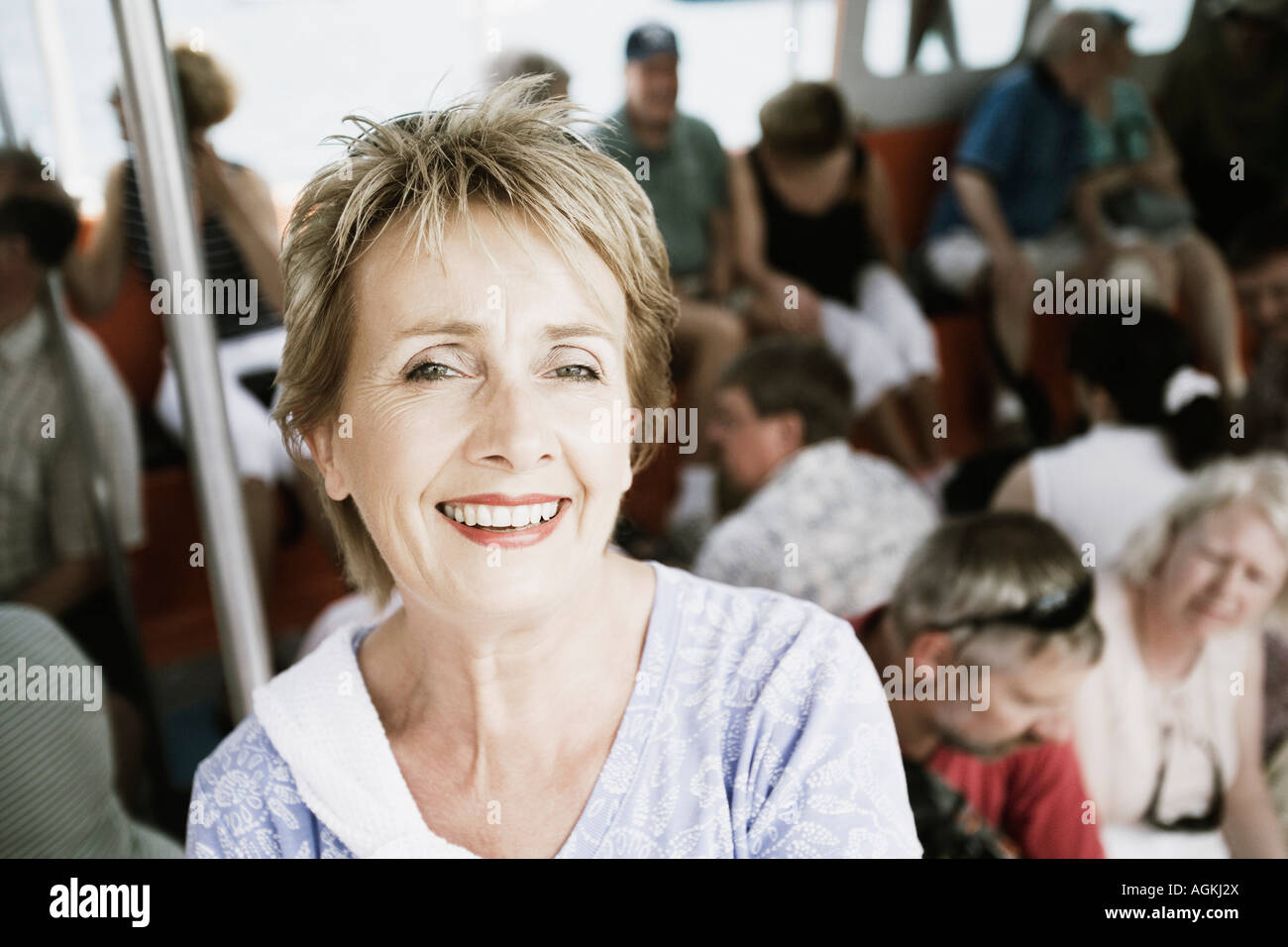 Portrait of a mature woman smiling in a ferry Stock Photo - Alamy