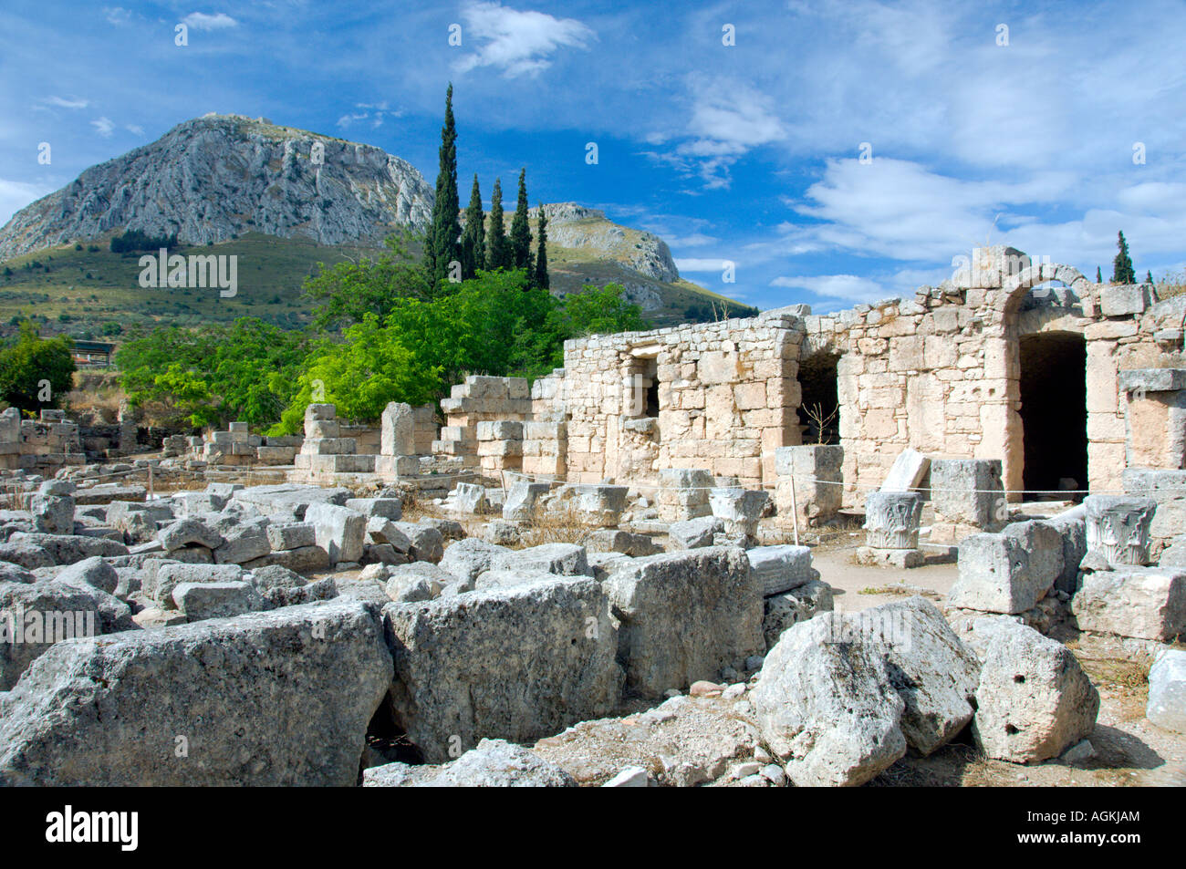 Ruins of the ancient city of Corinth with the Acropolis of Acrocorinth ...
