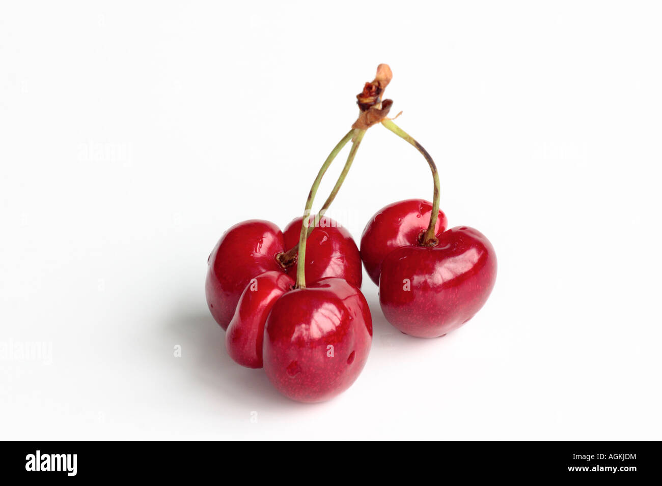 Three cherries on white background Stock Photo - Alamy