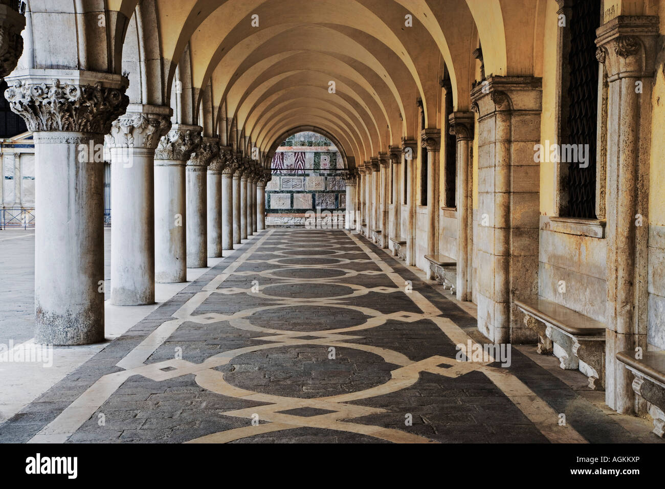 Europe, Italy, Venice. Columns and archways along a patterned ...