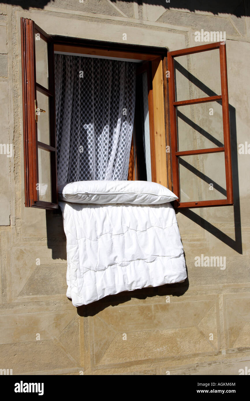 Bedding is aired at a window. Photo by Willy Matheisl Stock Photo - Alamy