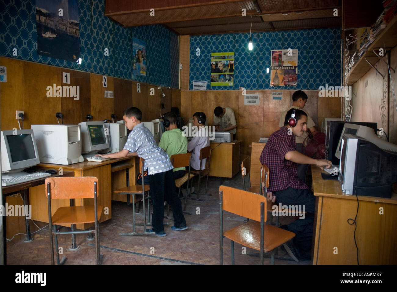 Kids playing computer games in internet cafe at the historic village ...