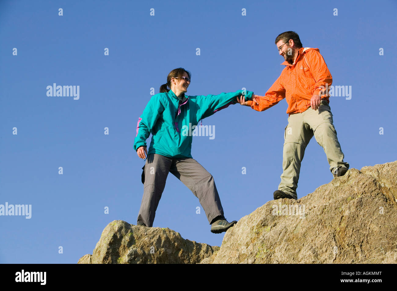 A man and woman scrambling on Great Carrs, Lake District, UK Stock ...