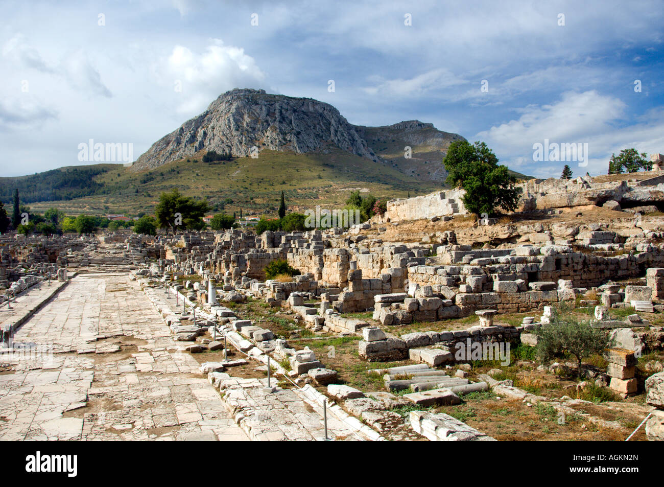 Ruins of the ancient city of Corinth with the Acropolis of Acrocorinth ...
