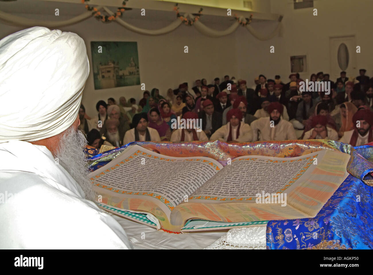 Sikh priest reading from holy scripture called Guru Granth Sahib Stock ...