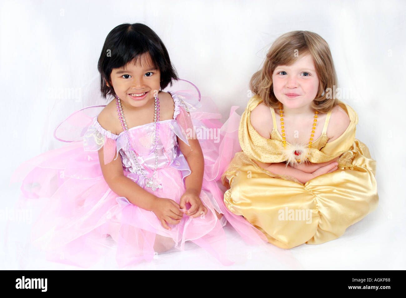 two girls different ethnic white background Stock Photo - Alamy