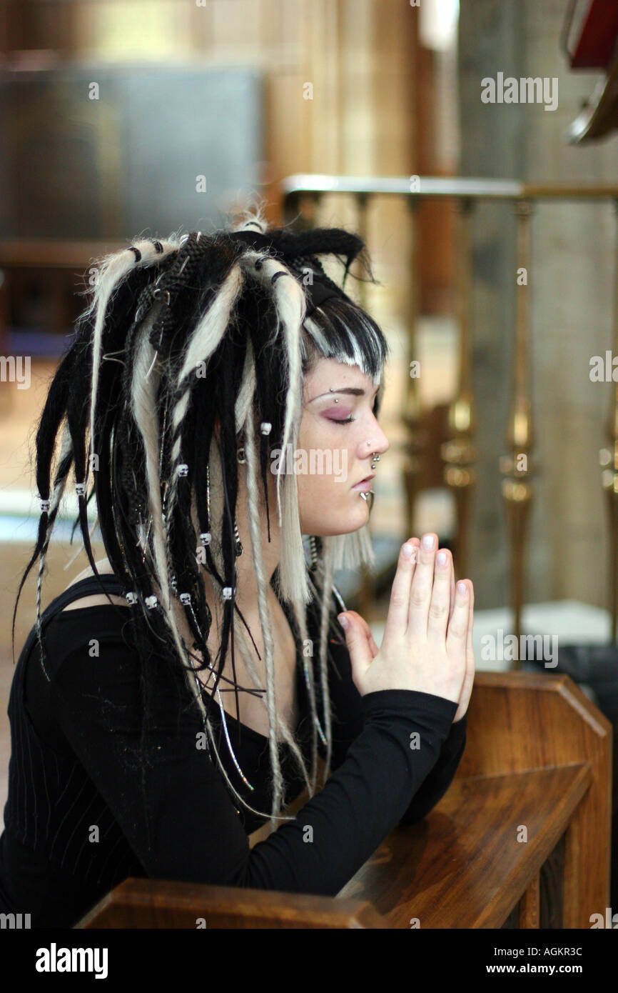 gothic girl praying inside church Stock Photo - Alamy