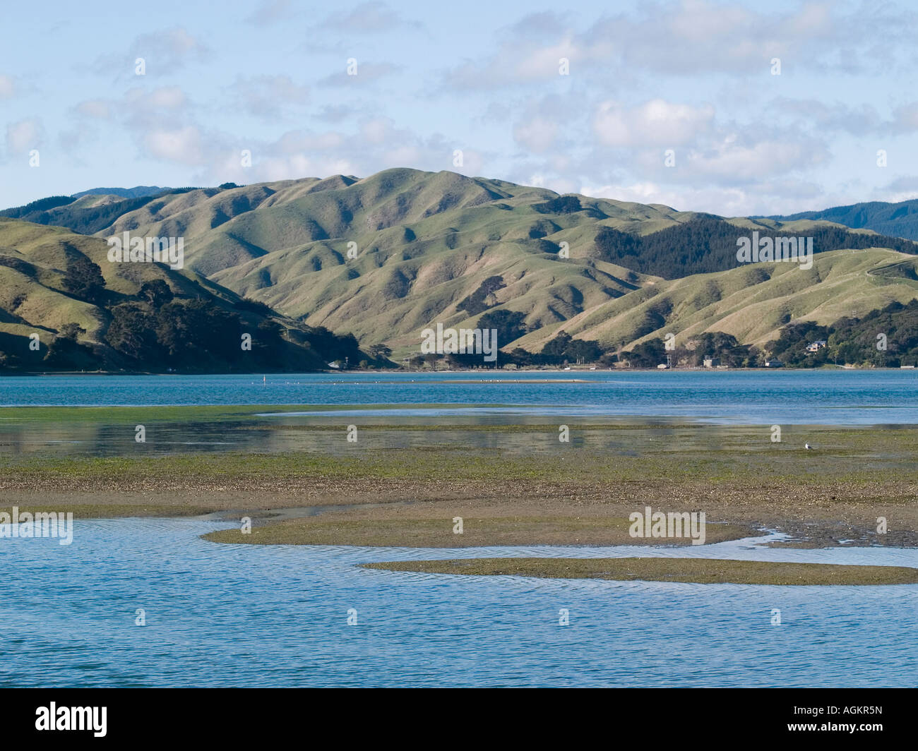 The blue sea sand sky and hills of Pauatahanui Inlet estuary Wellington ...