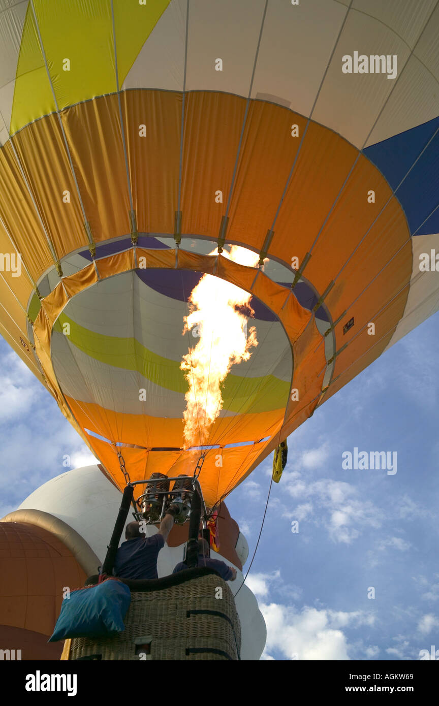flame from a hot air balloon lifting into blue sky Stock Photo - Alamy