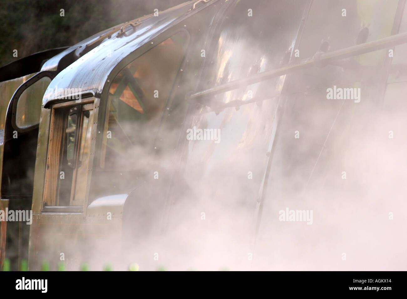 Steam engine shrouded in the mist as it blows off excess steam from its ...
