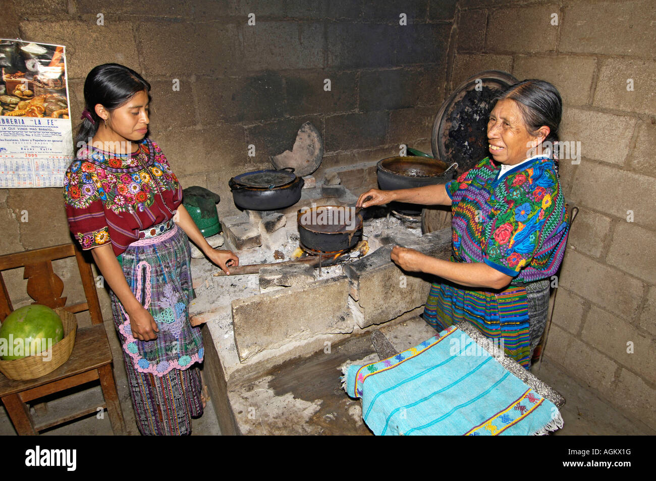 Guatemala, Antigua, Older and younger Guatemalan women cooking on wood ...