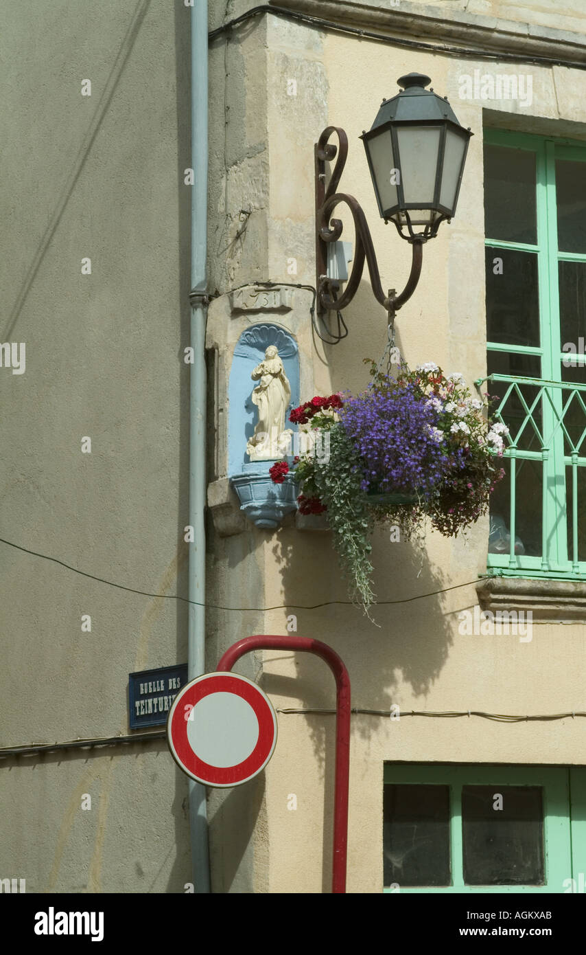 Street corner lamp flowers roadsign statue cluttered sees normandy ...