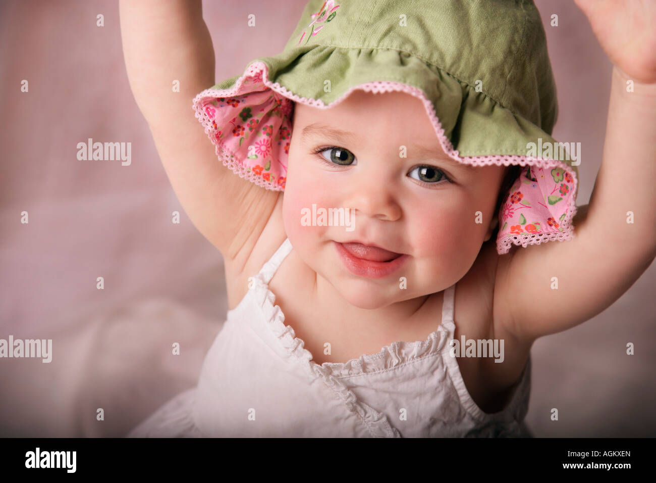 Baby lifting her arms Stock Photo - Alamy