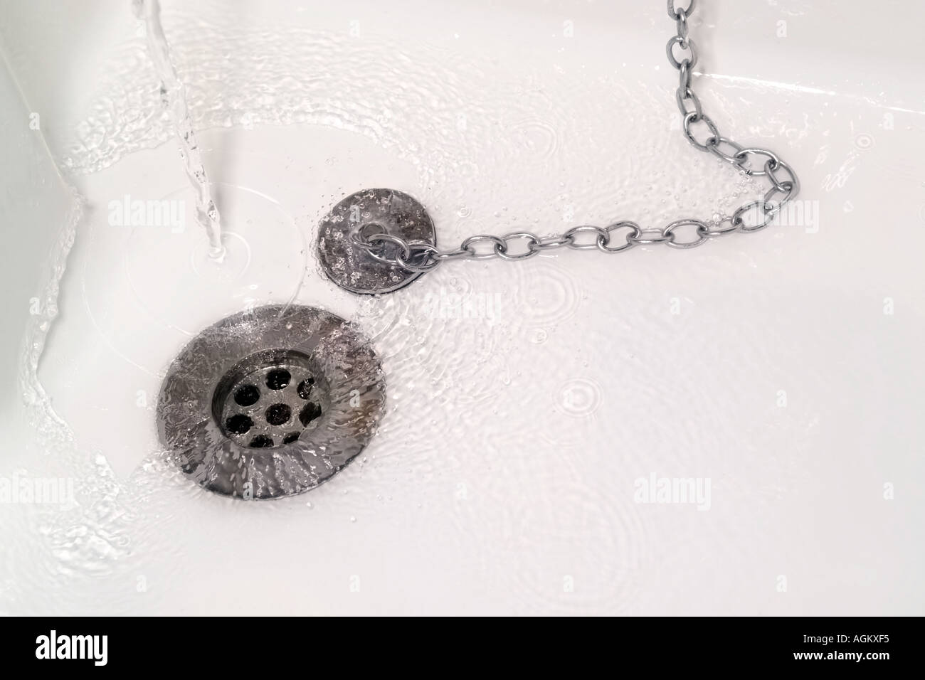 water down plughole white sink Stock Photo - Alamy