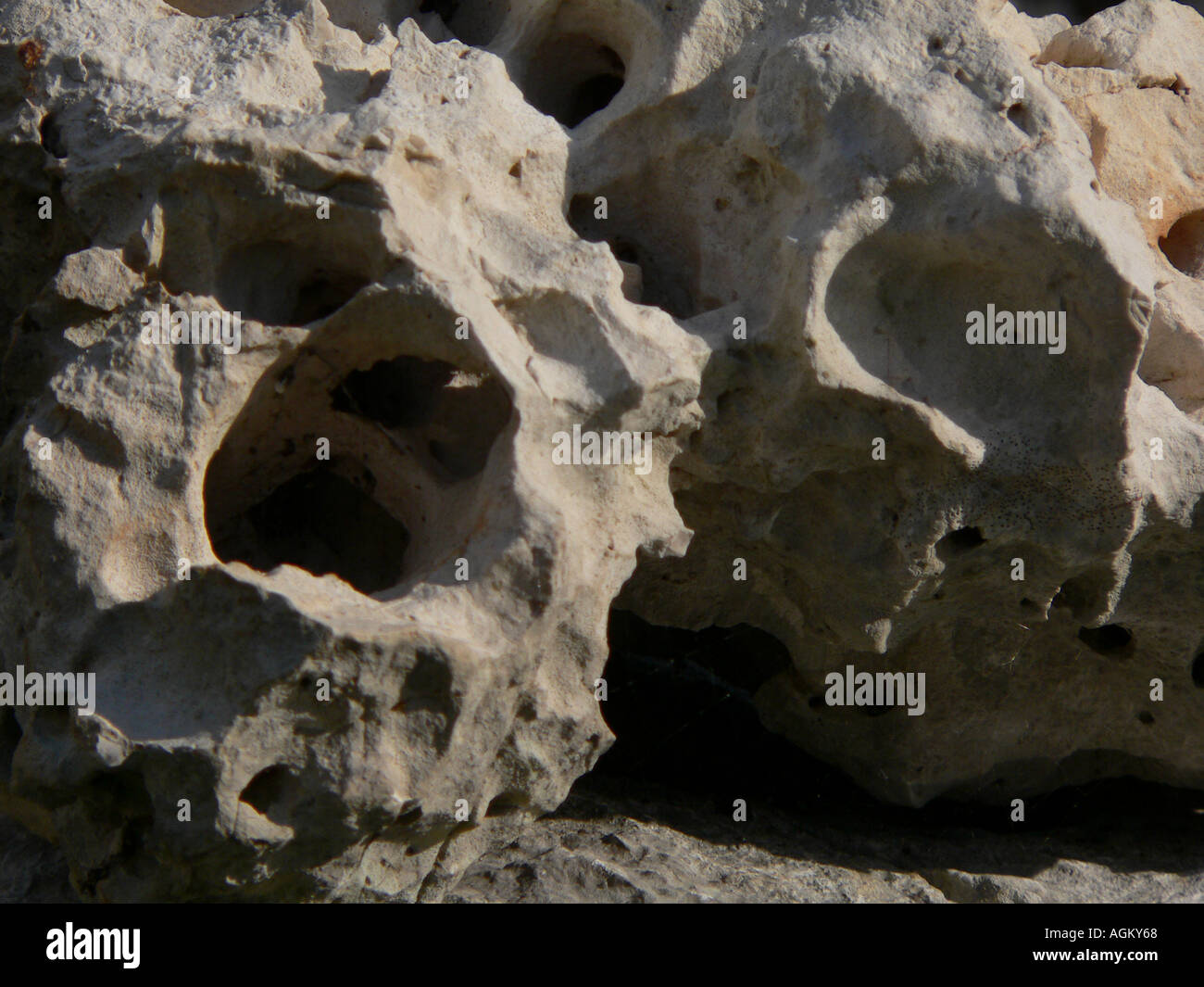 Concept stone with holes Stock Photo - Alamy