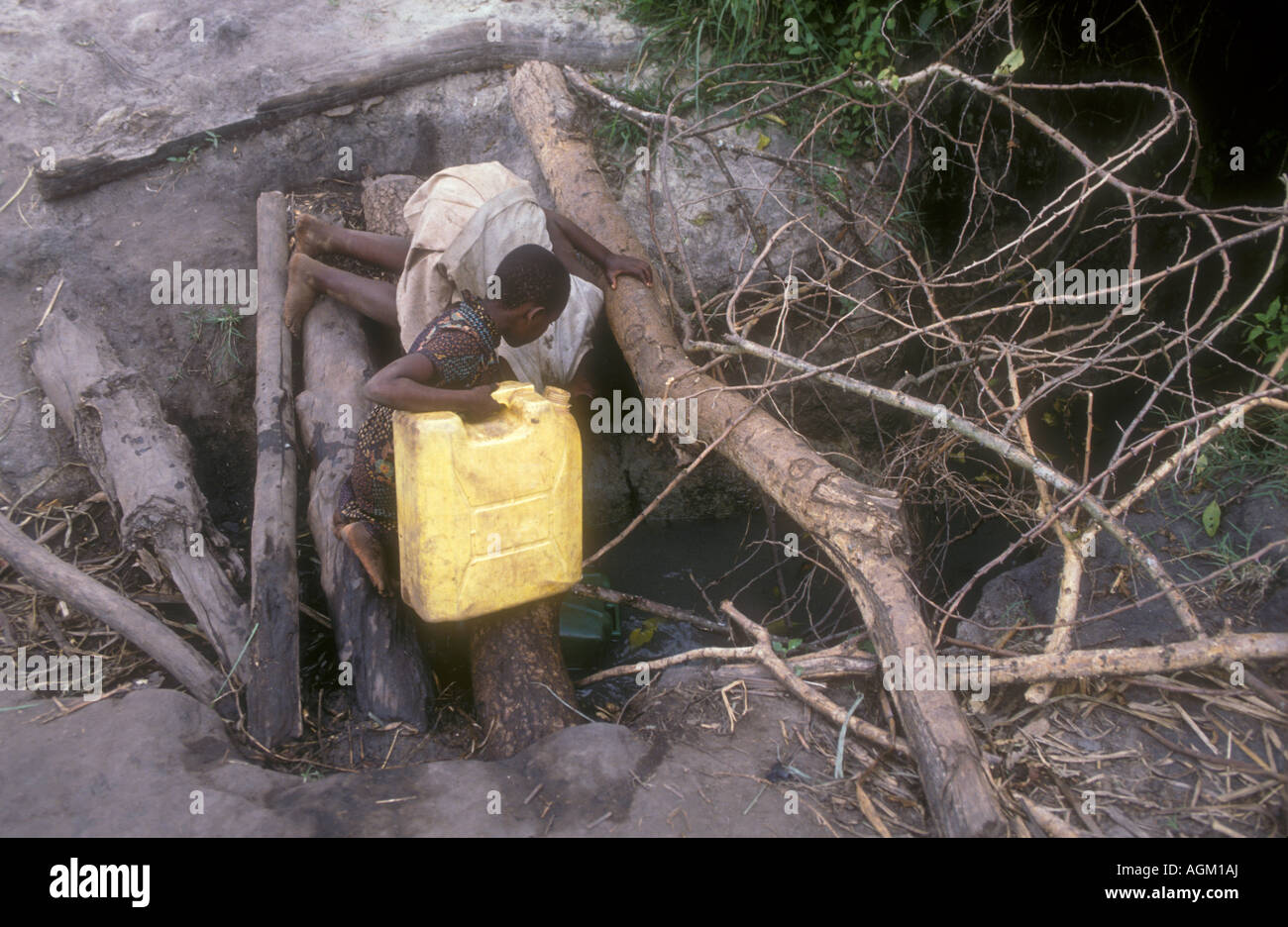 Children fetching water from a well, Uganda Stock Photo - Alamy