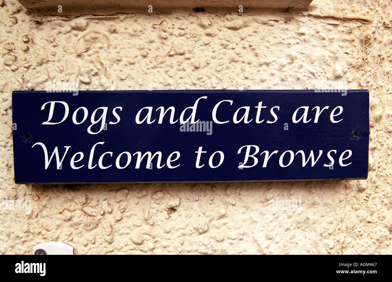 Dogs and cats are welcome to browse sign outside a shop in Britain UK ...