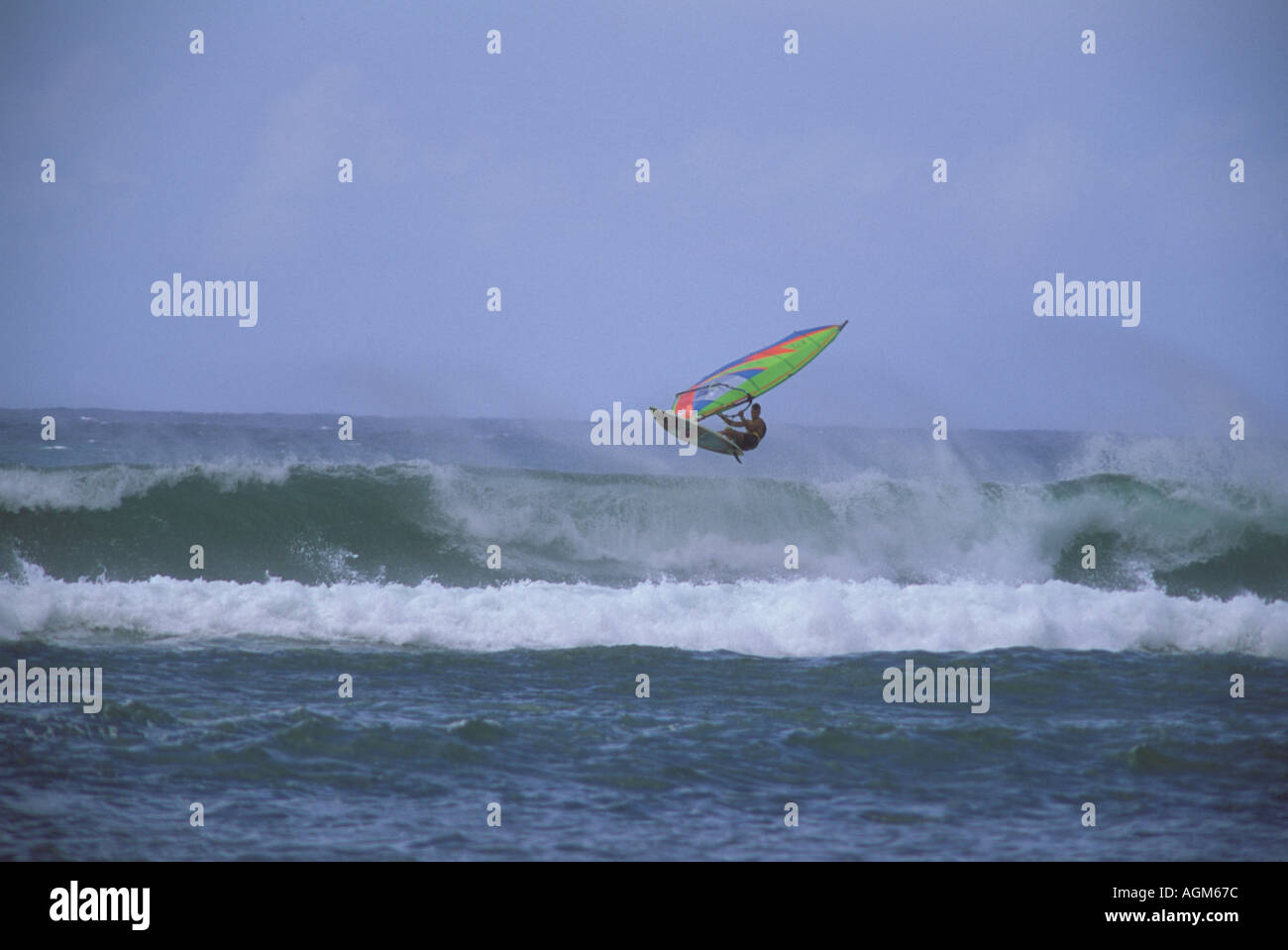 Windsurfer jumping large wave on North Shore Island Oahu Hawaii USA ...