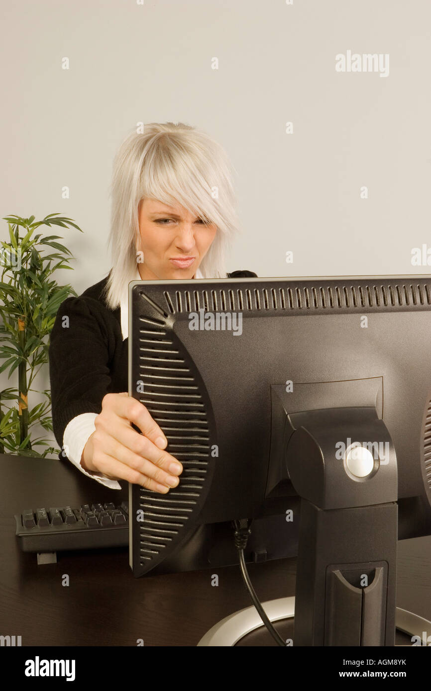 Lady frowning at computer screen Stock Photo - Alamy
