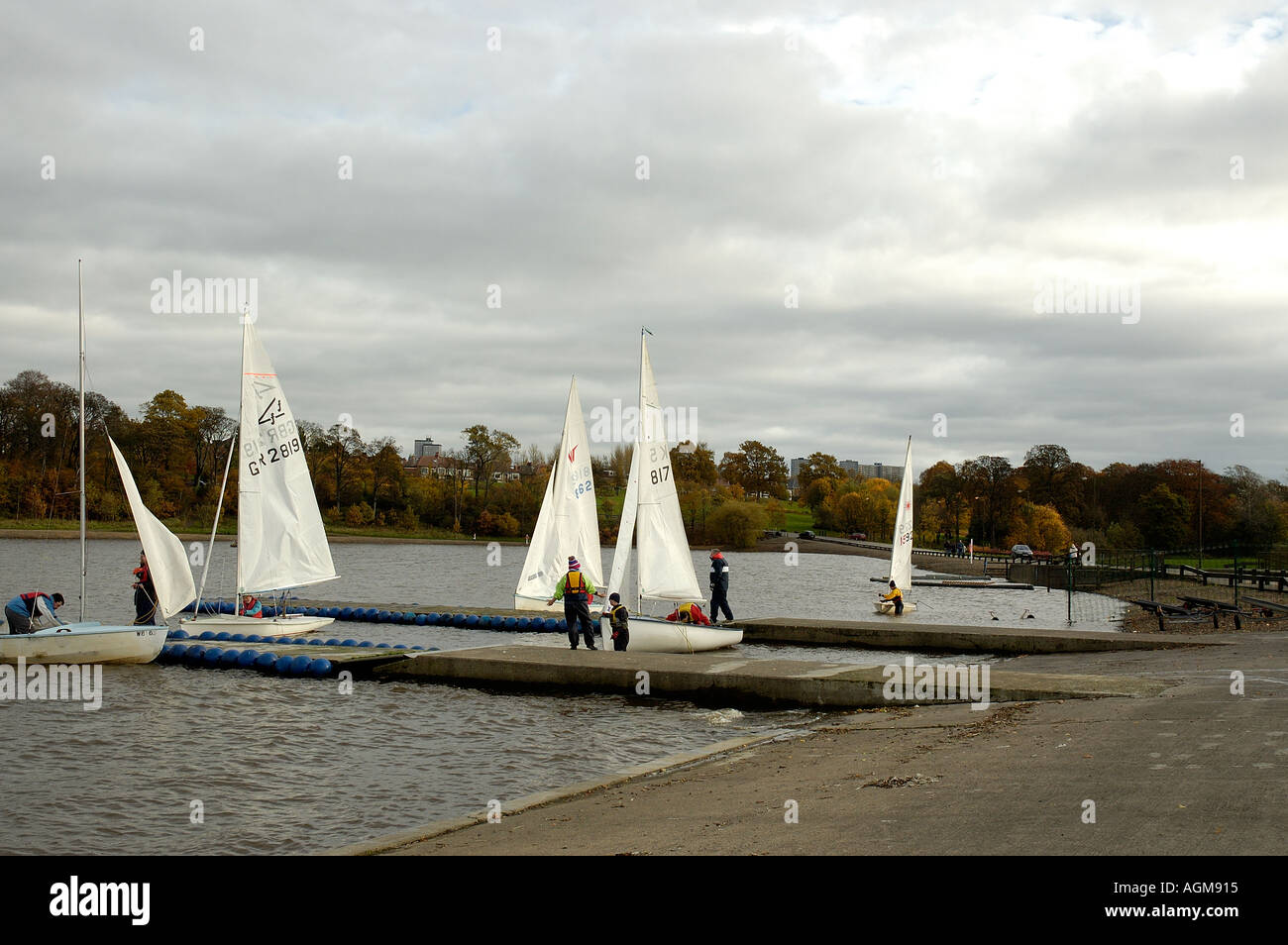 dinghy sailors on Strathclyde Loch Strathclyde Country Park Motherwell Lanarkshire Scotland ...