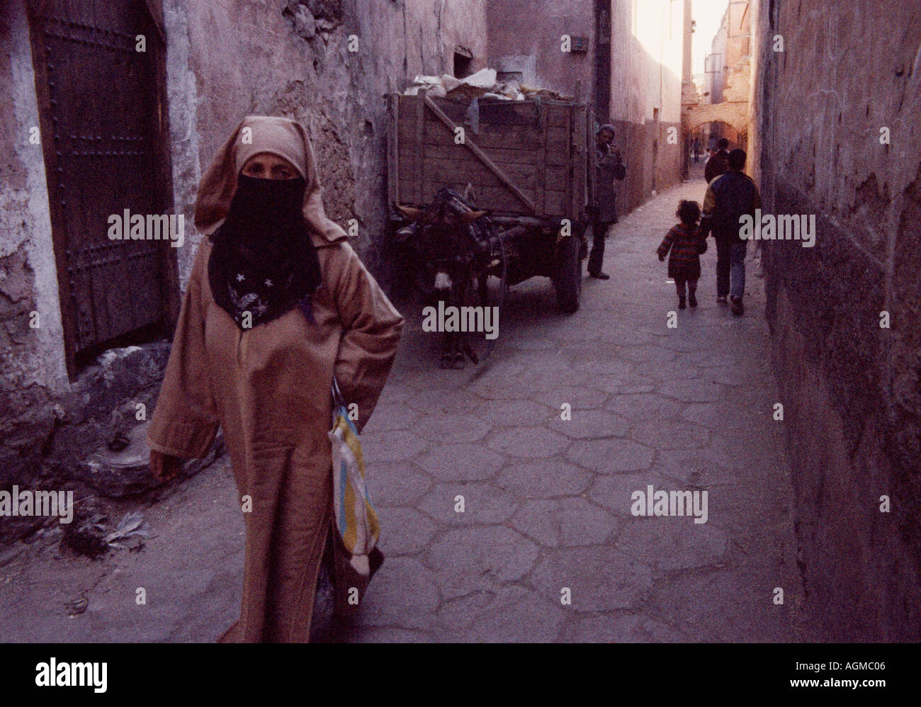 Woman veiled in a yashmak in the medina souk of Marrakech Marrakesh ...