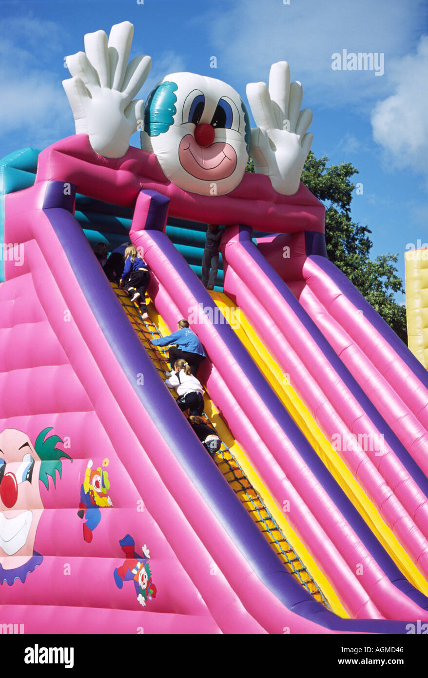 Colourful Bouncy Slide at Fair with Several Children Climbing Side ...