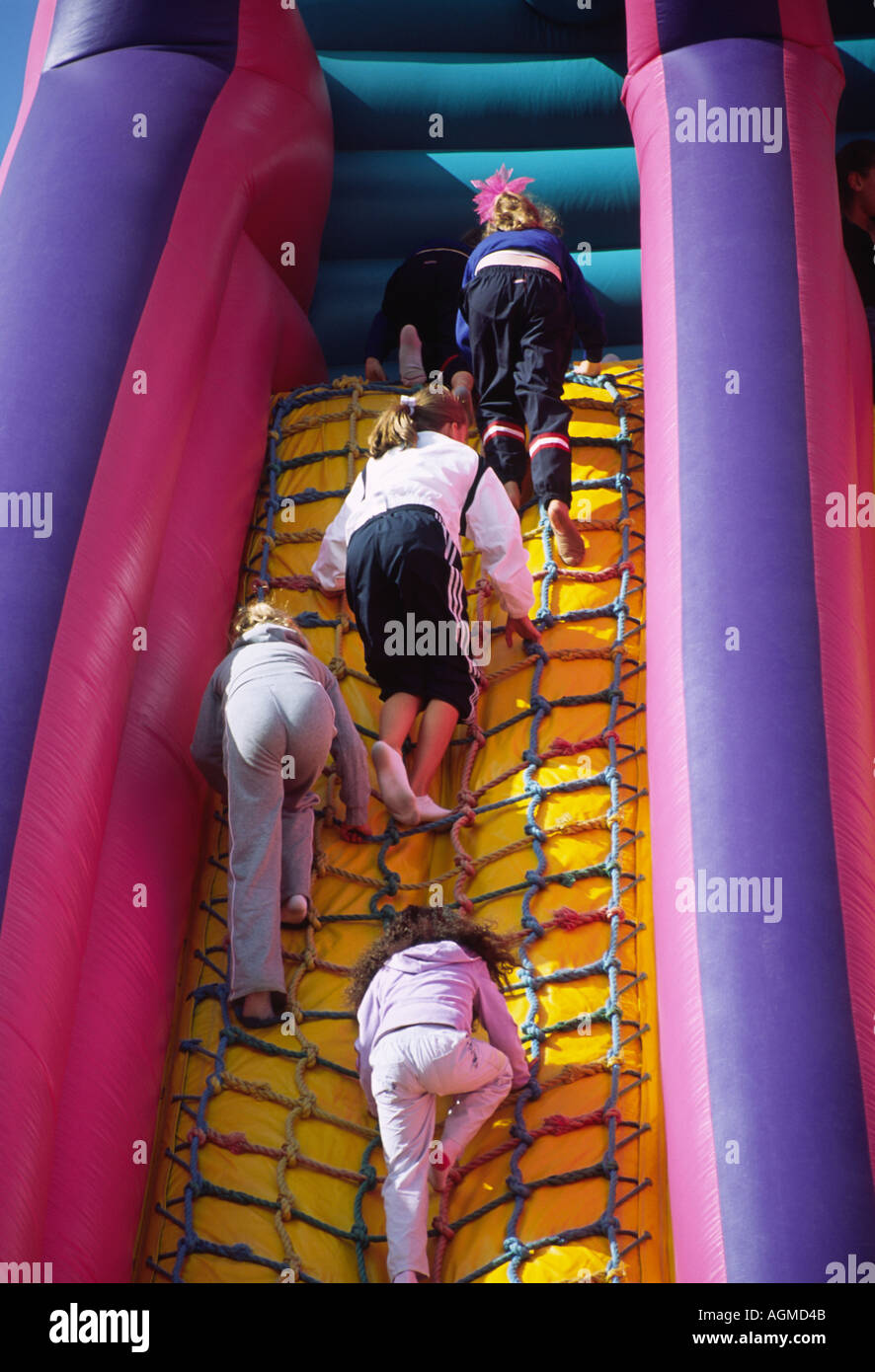 Five Children Climbing Side Section of Fairground Slide Stock Photo - Alamy