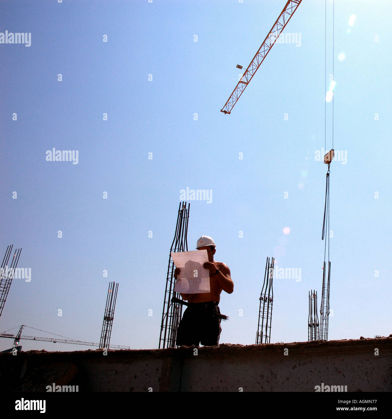 Spanish worker studies plan at building site Stock Photo - Alamy
