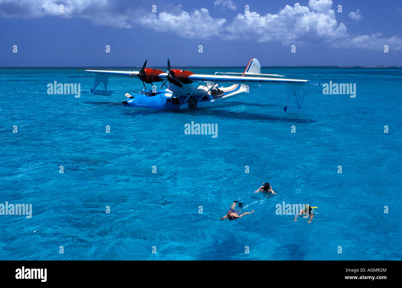 Bahamas, Bimini, Catalina hydroplane resting on water People swimming ...