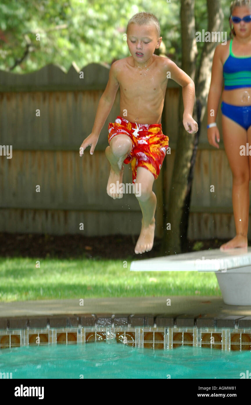 Boy jumps into pool Stock Photo - Alamy