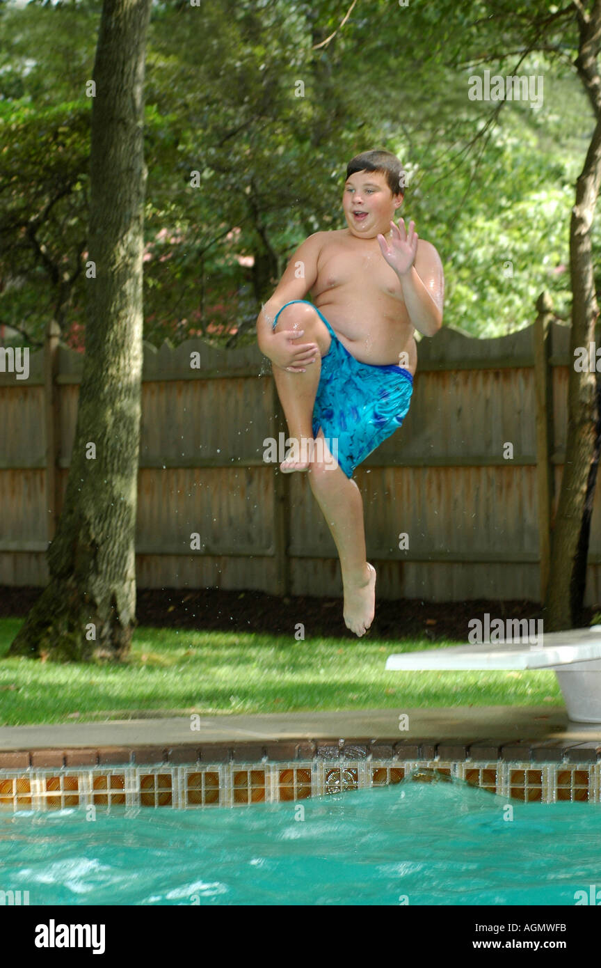 Boy jack knifes into pool Stock Photo - Alamy