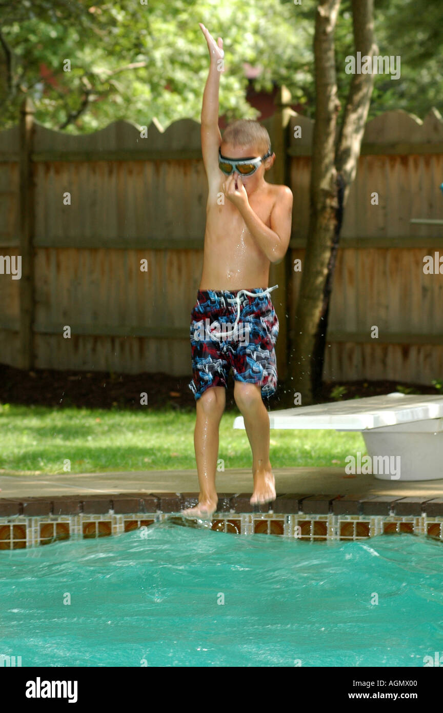 Boy jumps into pool Stock Photo - Alamy
