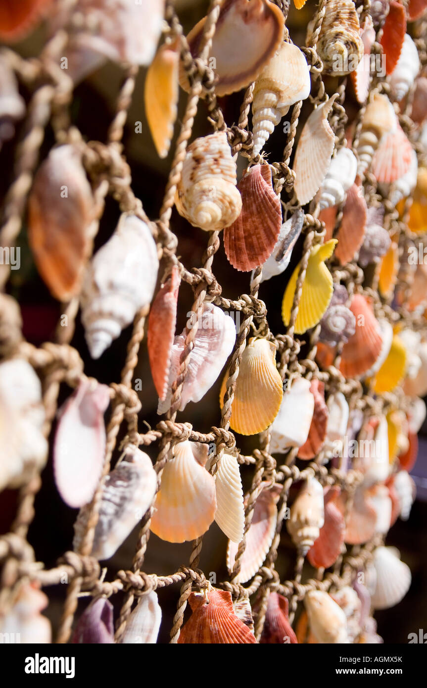 Hanging screen made of string and small shells tied on. They jangle in ...