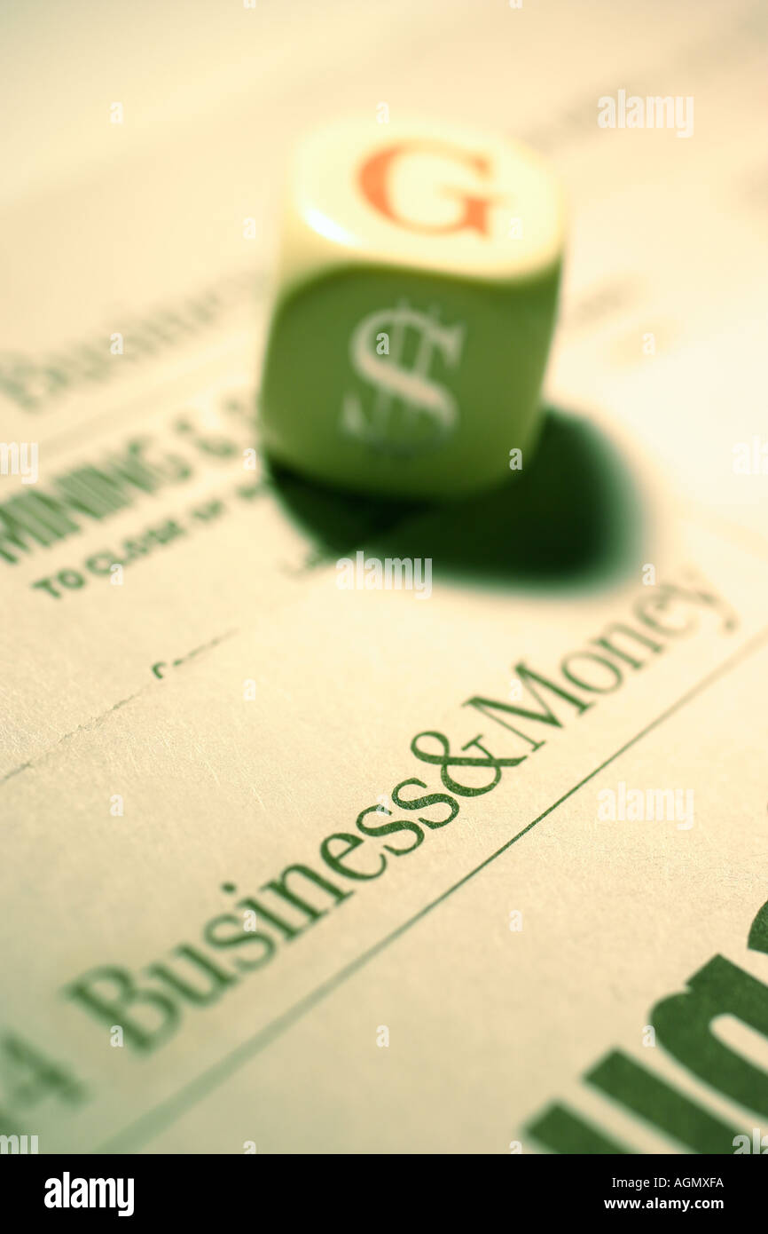 Dollar Sign Die on Business Newspapers Stock Photo - Alamy