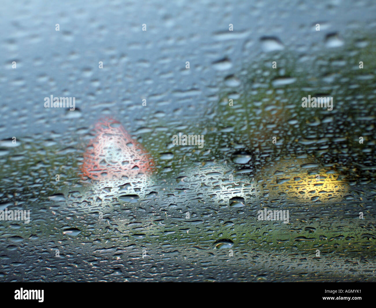 Rain on the windscreen whilst driving through a summer storm, roadwork ...