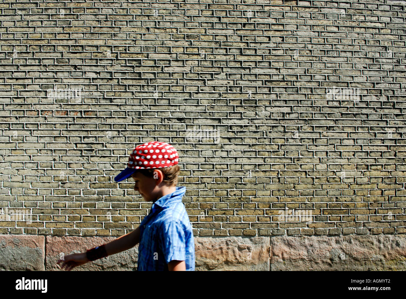 BOY AND BRICK WALL Stock Photo - Alamy