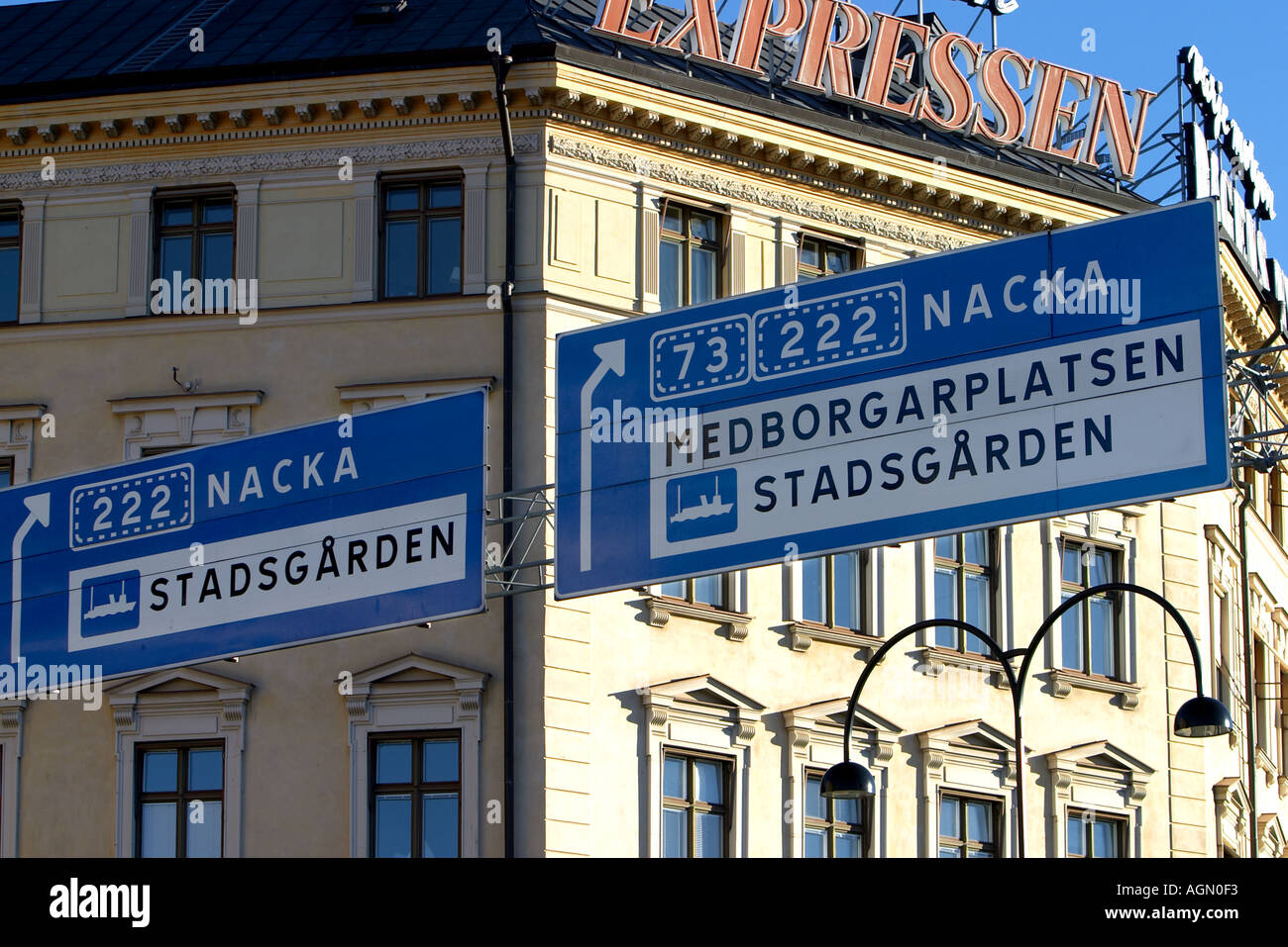 Road signs in central Stockholm Sweden with shop and Gamla Stan behind ...