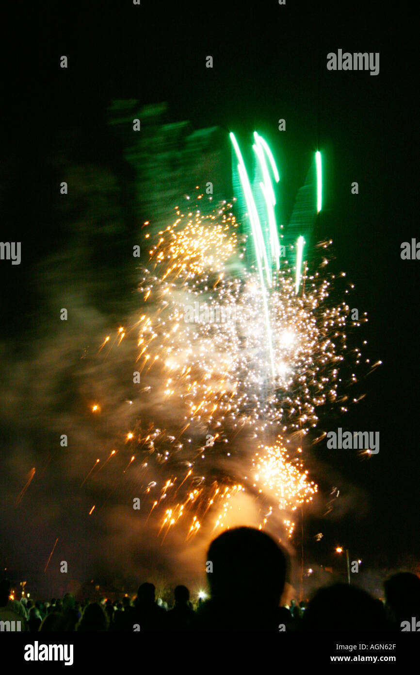 A crowd of people watching a firework display Stock Photo - Alamy