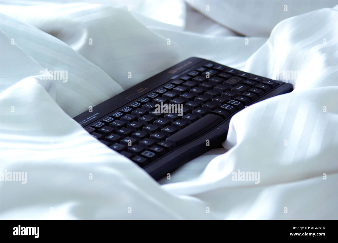 Black keyboard on a bed Stock Photo - Alamy
