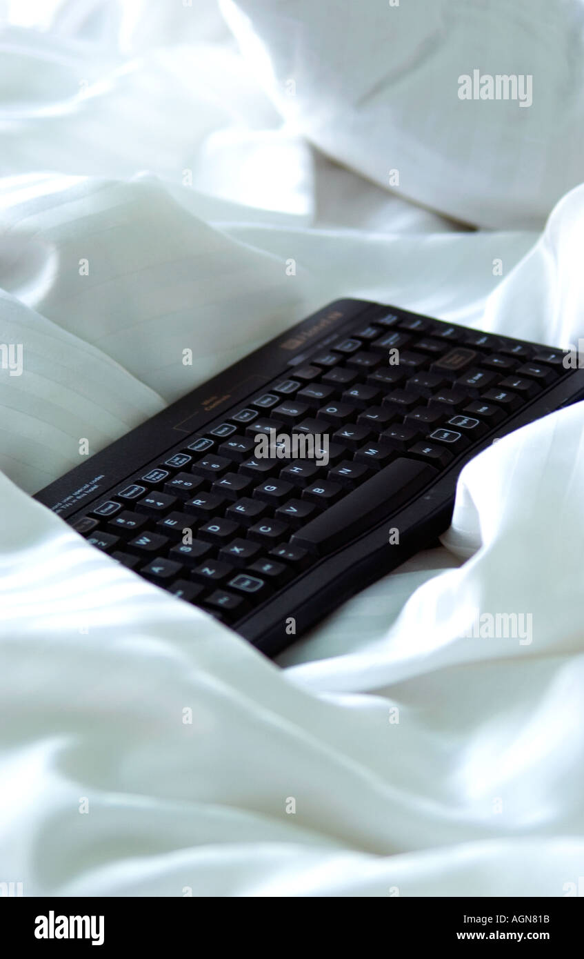 Black keyboard on a bed Stock Photo - Alamy