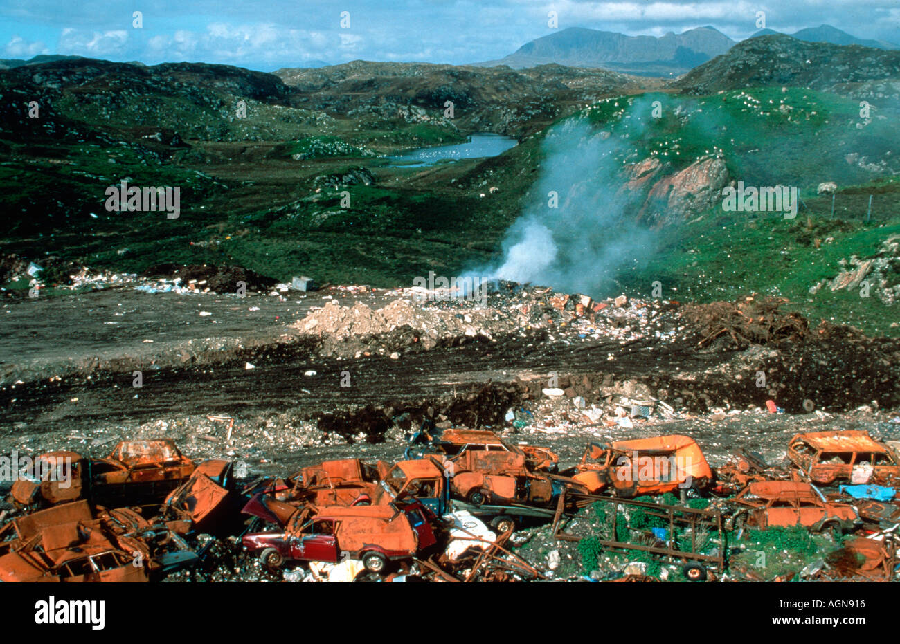 Burning rubbish vehicles dumped in open landfill site Scotland UK Stock ...