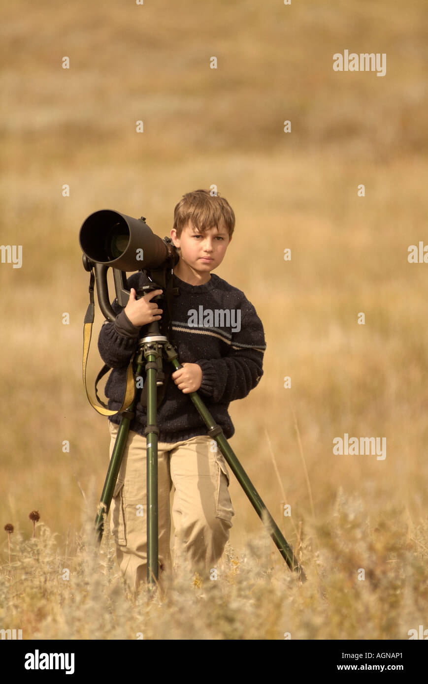 Boy with a very large camera Stock Photo - Alamy