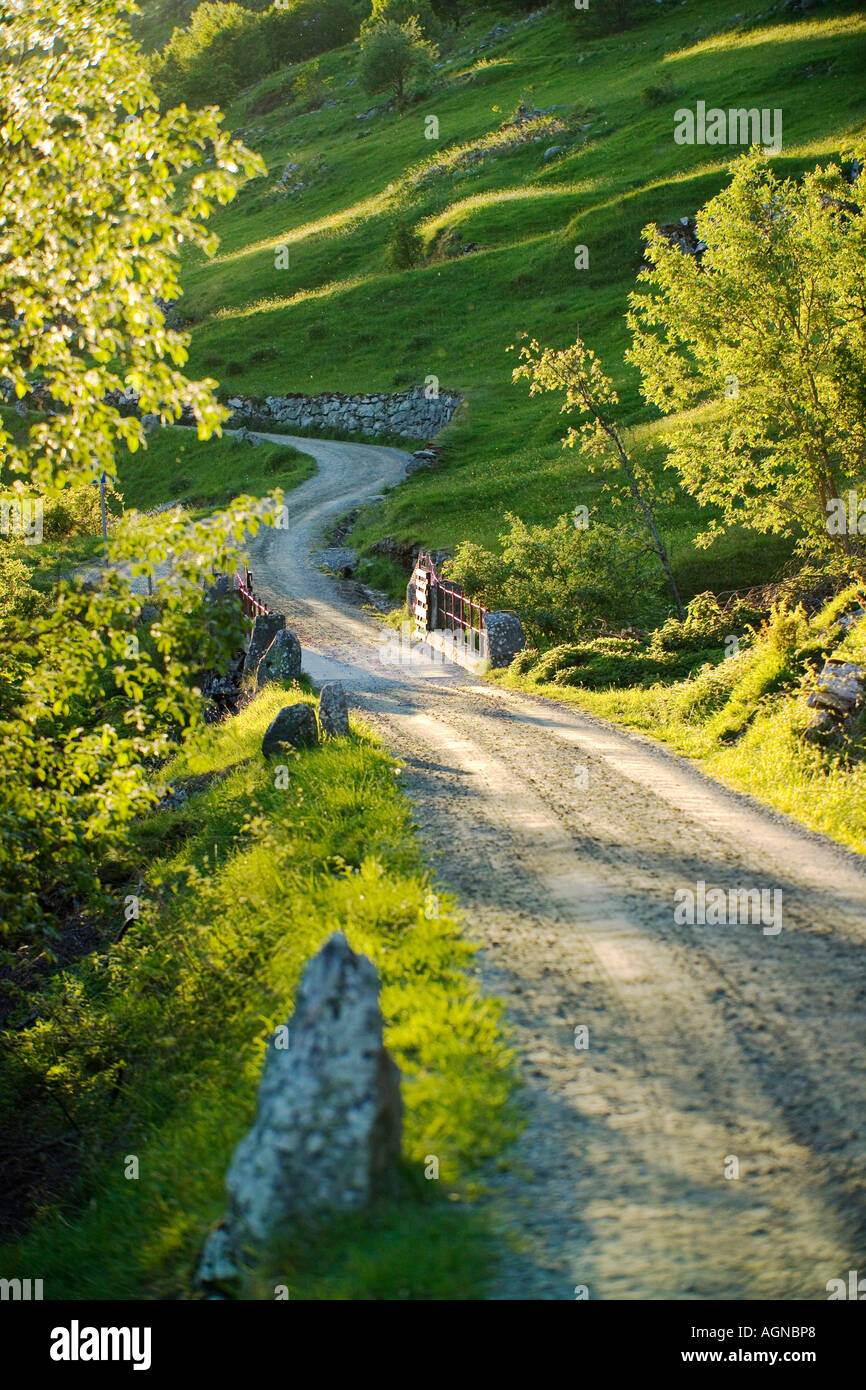 Old winding road with safety stones on the hillside above Geiranger ...