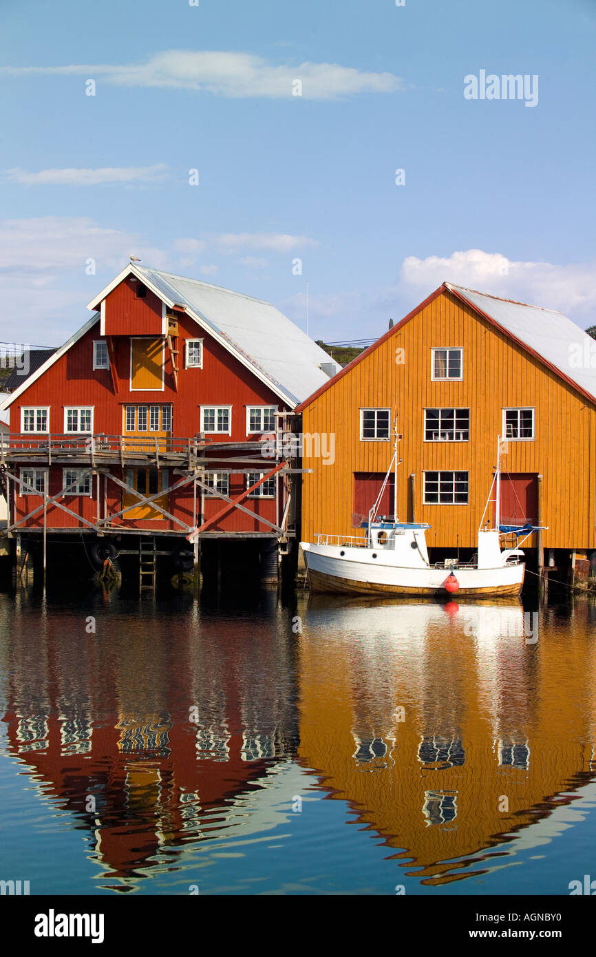 Fishing boat docked in front of traditional boathouses Bud More and ...