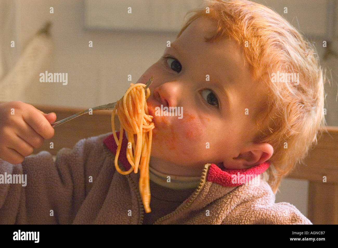 MR Child eating spaghetti pasta Stock Photo - Alamy